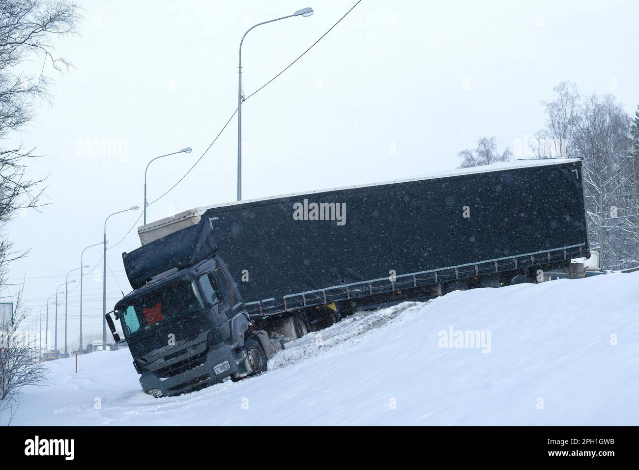 Main truck with a semi-trailer flew off the track in heavy snowfall ...