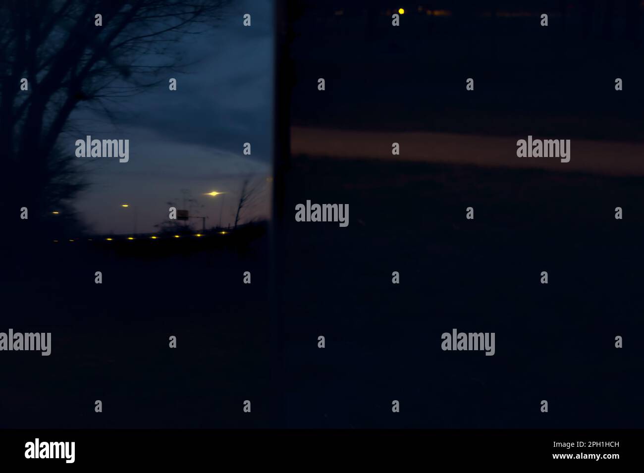 Cloudy sky at dusk and trees seen in a distorted mirror Stock Photo - Alamy