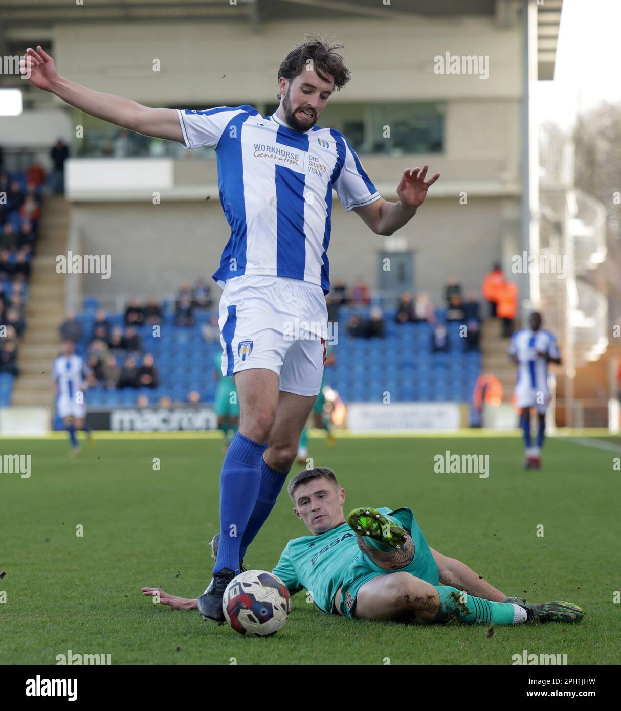 Fiacre Kelleher of Colchester United is tackled by Harvey Saunders of ...