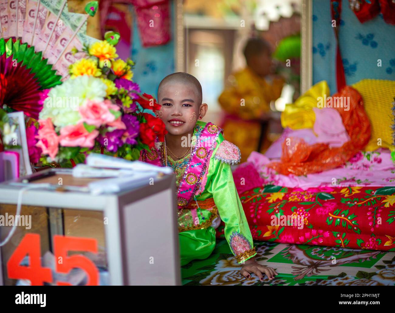 A young ethnic Shan boy dressed in colorful costume smiles during the ...