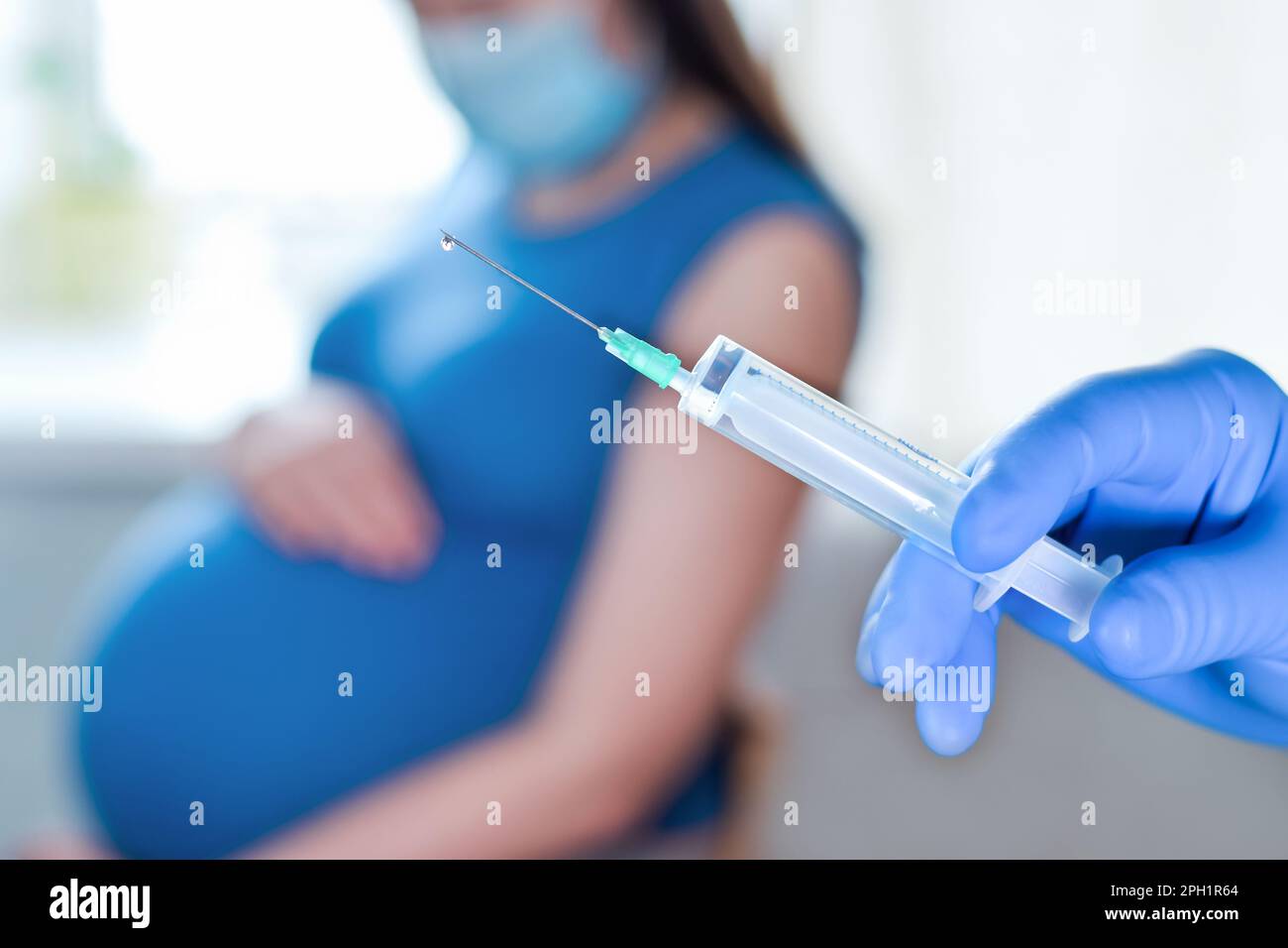 Pregnant Vaccination. Pregnant Woman In Face Mask Getting Vaccinated in ...