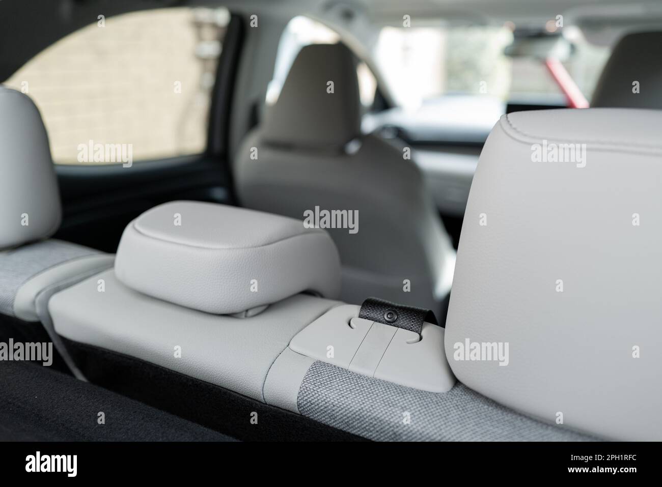 Shallow focus of the central, rear headrest seen in a hybrid vehicle ...