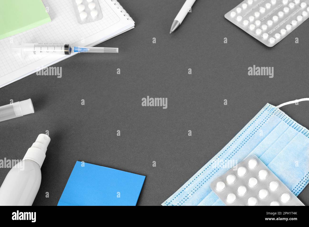 Gray modern doctor desk table with mask, notepad, syringe, sanitizer ...