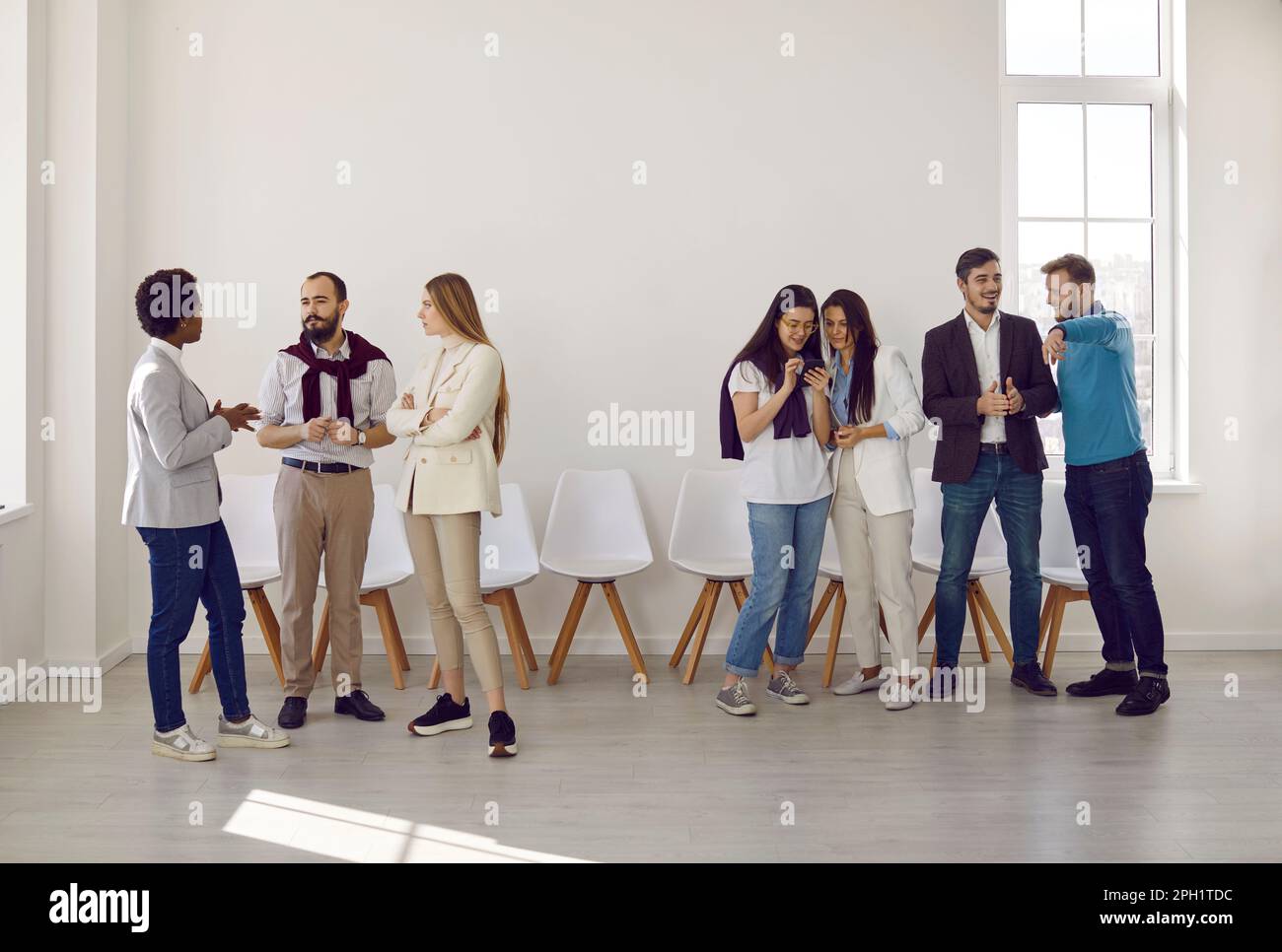 Group of people talking during casual office meeting Stock Photo - Alamy