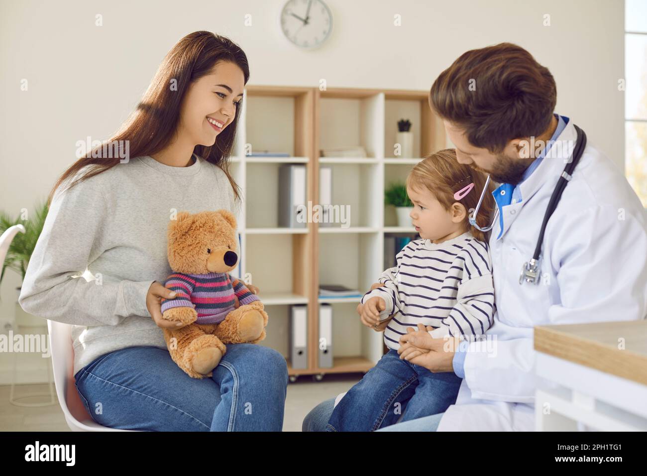 Male doctor pediatrician with baby patient and mother Stock Photo - Alamy