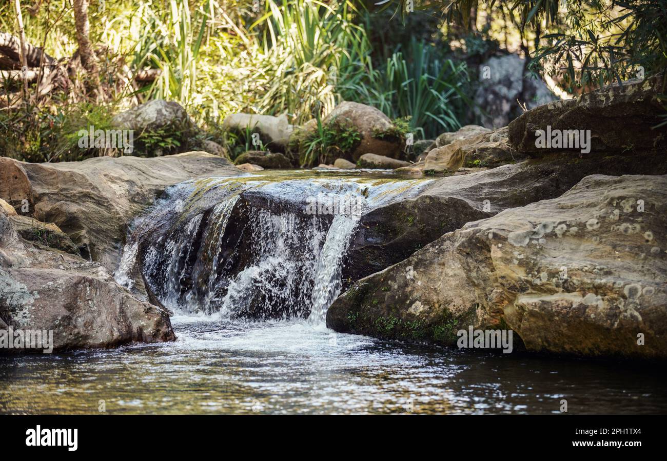 Small waterfall or river cascade - water flowing over large stones ...