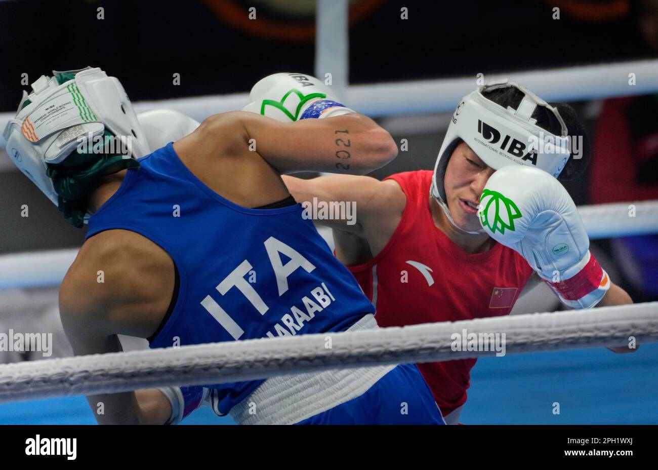 China's Wu Yu, in red, exchanges punches with Italy's Sirine Charaabi ...