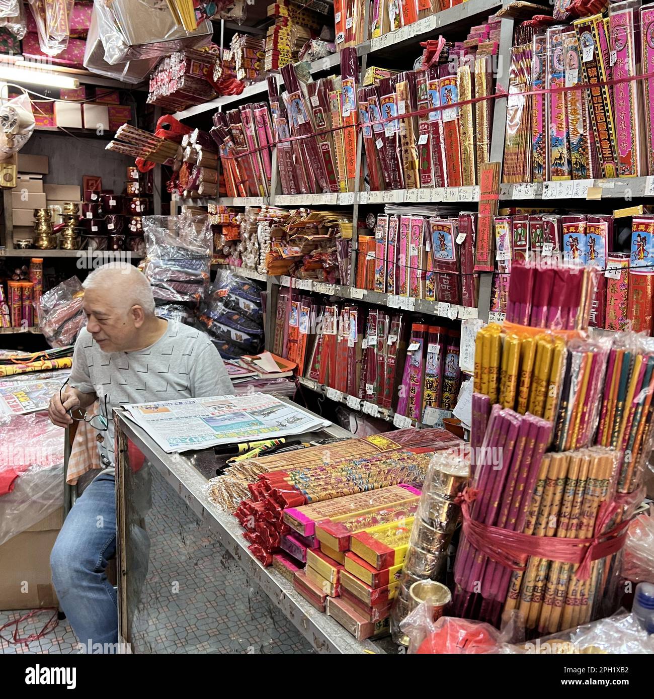 Mr Yik poses for pictures in his incense shop at Shek Wai Kok ...