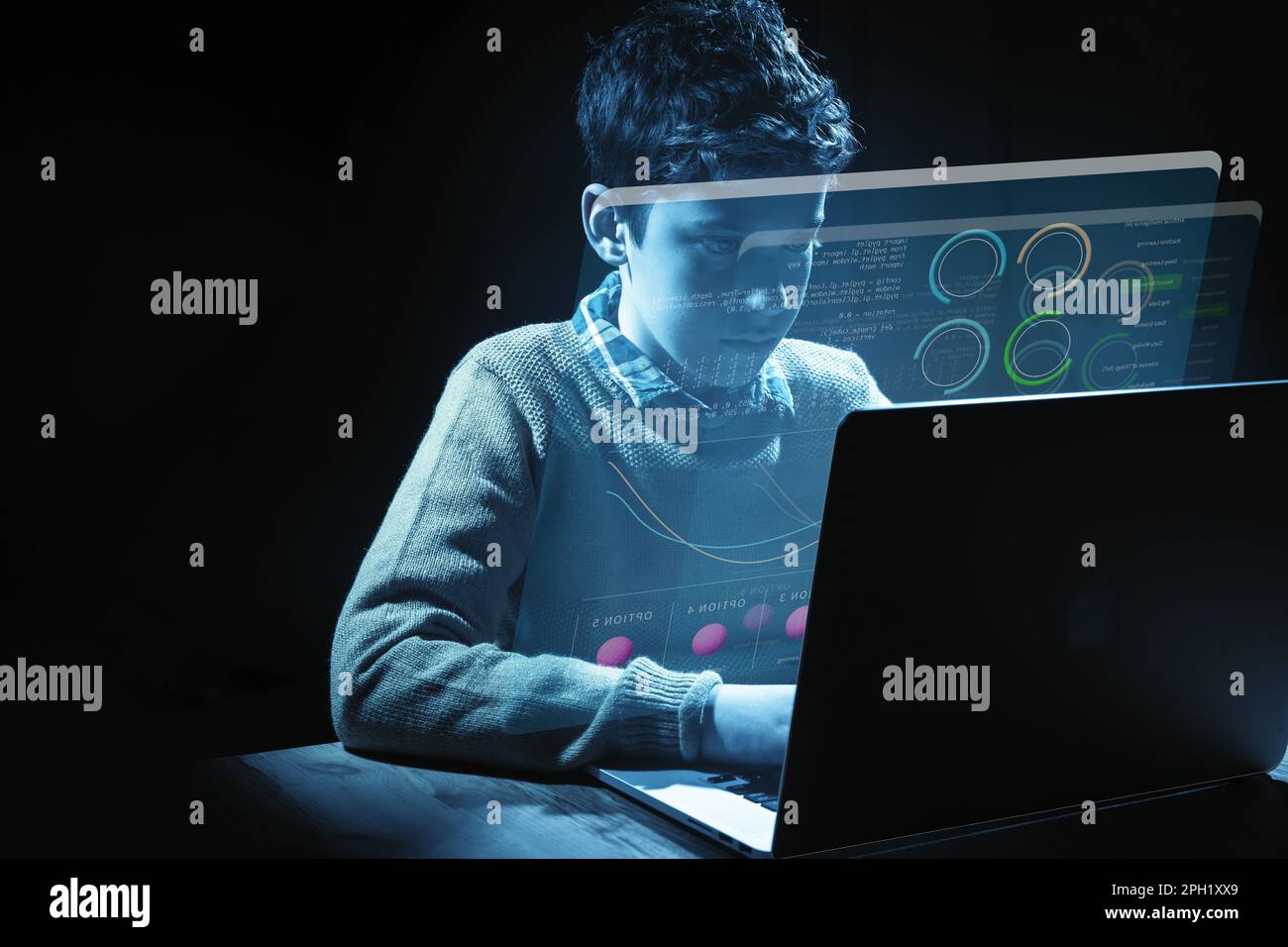 A 10-year-old boy types on a computer keyboard with a blue tint and ...