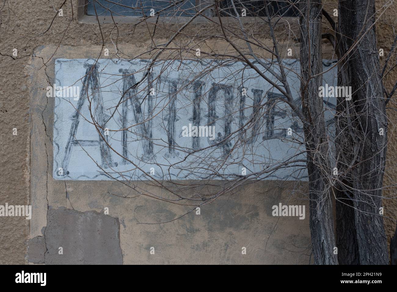 Sign painted on the stucco wall of an abandoned building in Yeso, New ...