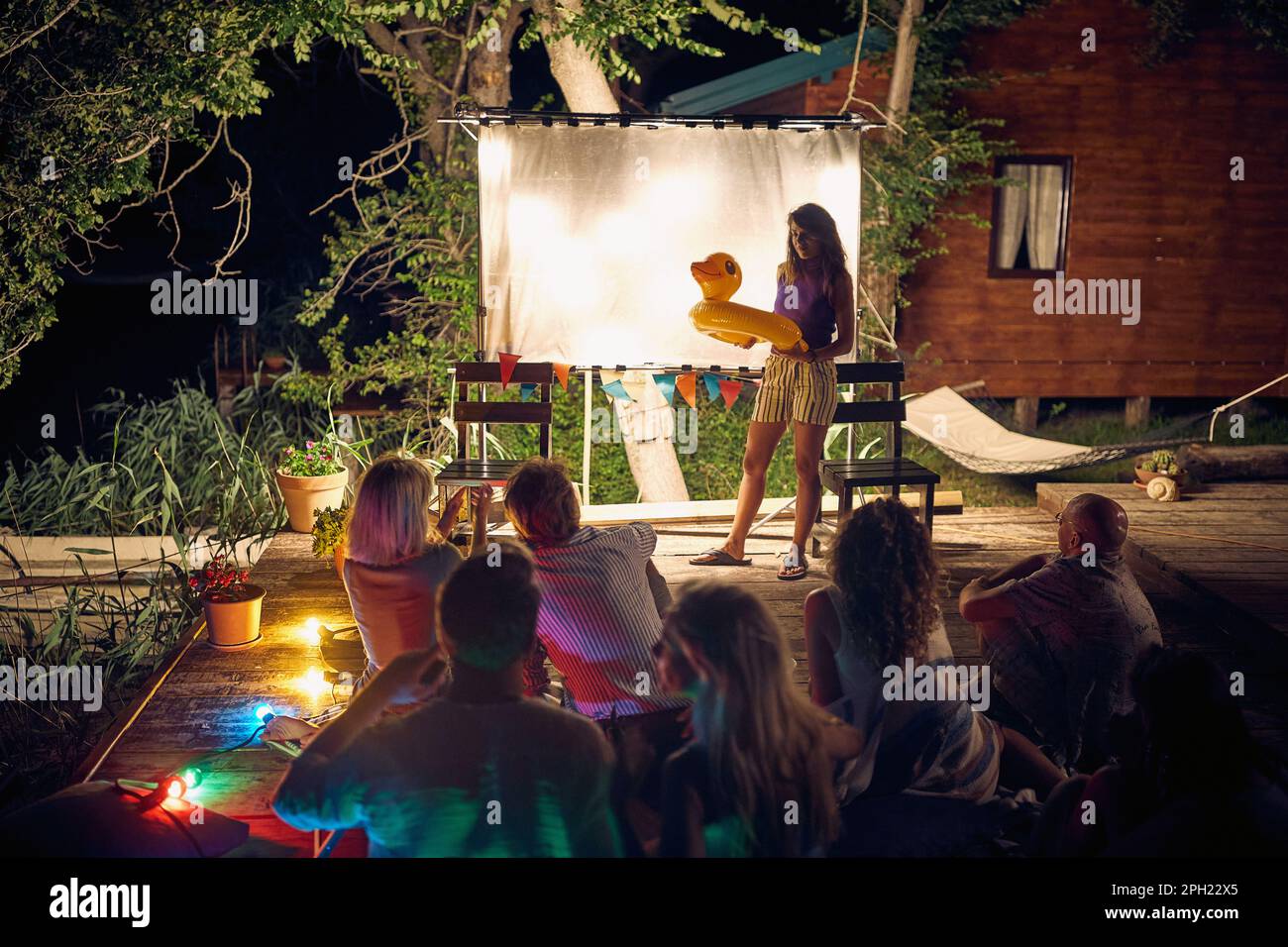 Group of people on presentation, movie night with outdoor cinema ...