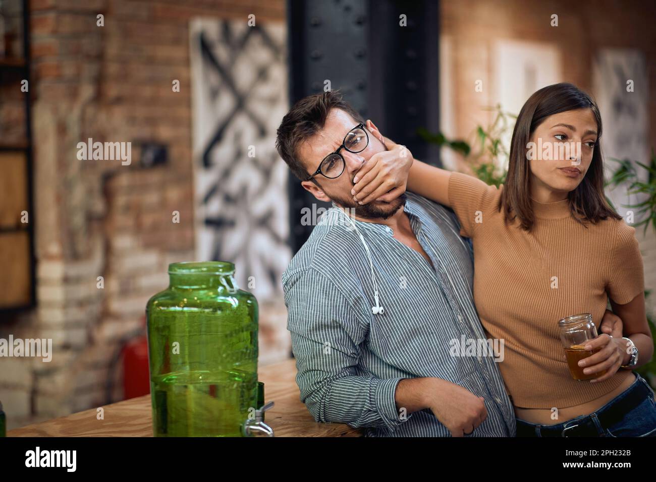 Young couple arguing in the bar. Woman holding her palm on her ...