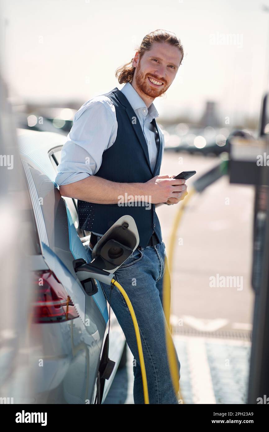 Young man fueling his car at the gas station Stock Photo - Alamy