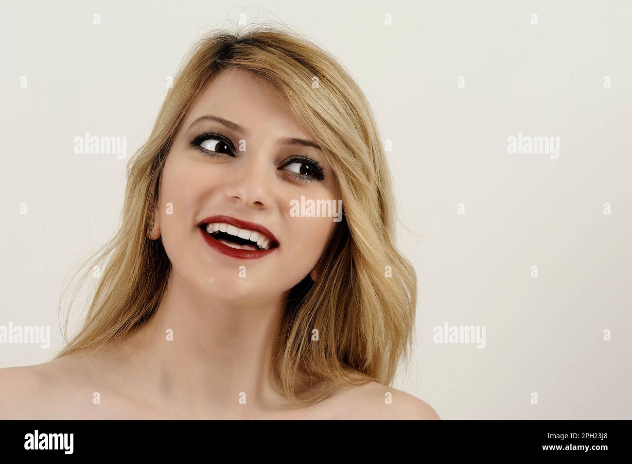 beautiful young woman with blonde and long hair and red lips laughing ...