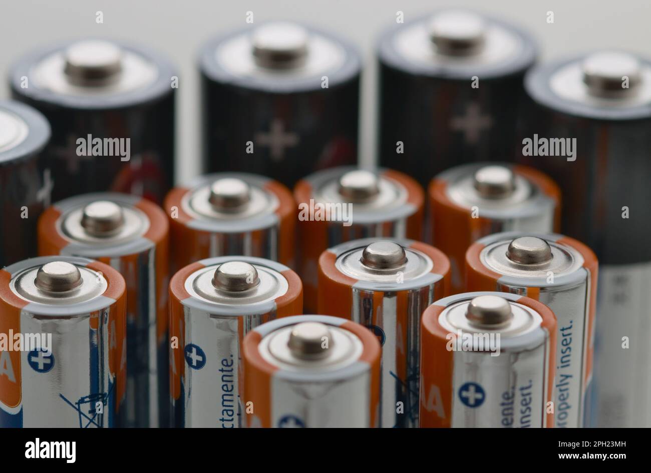 Flat lay of some AA and AAA type batteries standing upright against a ...