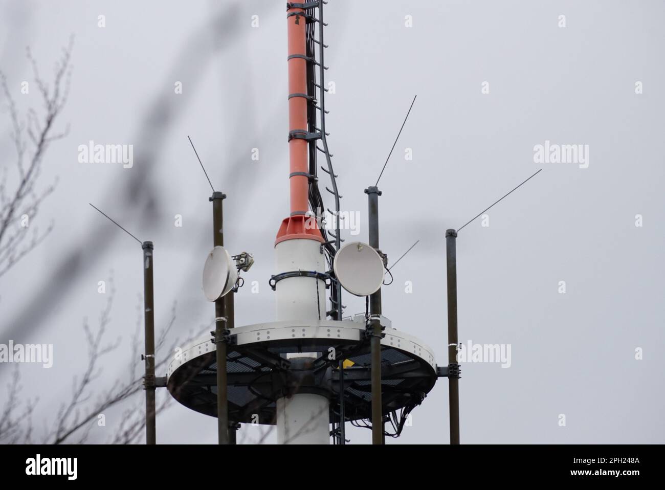 An industrial antenna tower with multiple cell phones mounted on the ...
