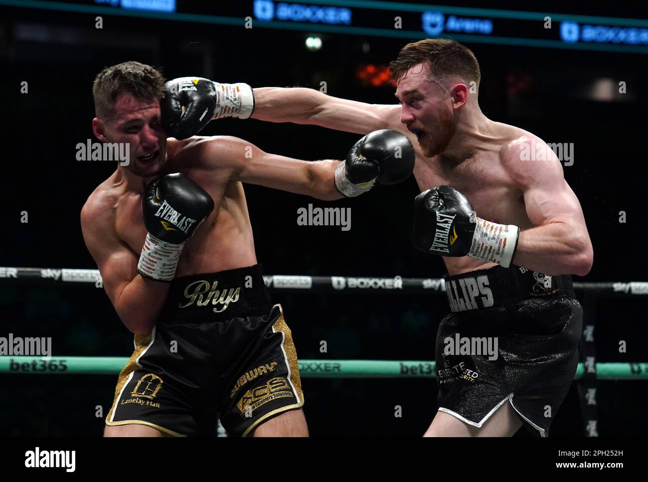 Rhys Edwards (left) and Brian Phillips in the super featherweight bout ...