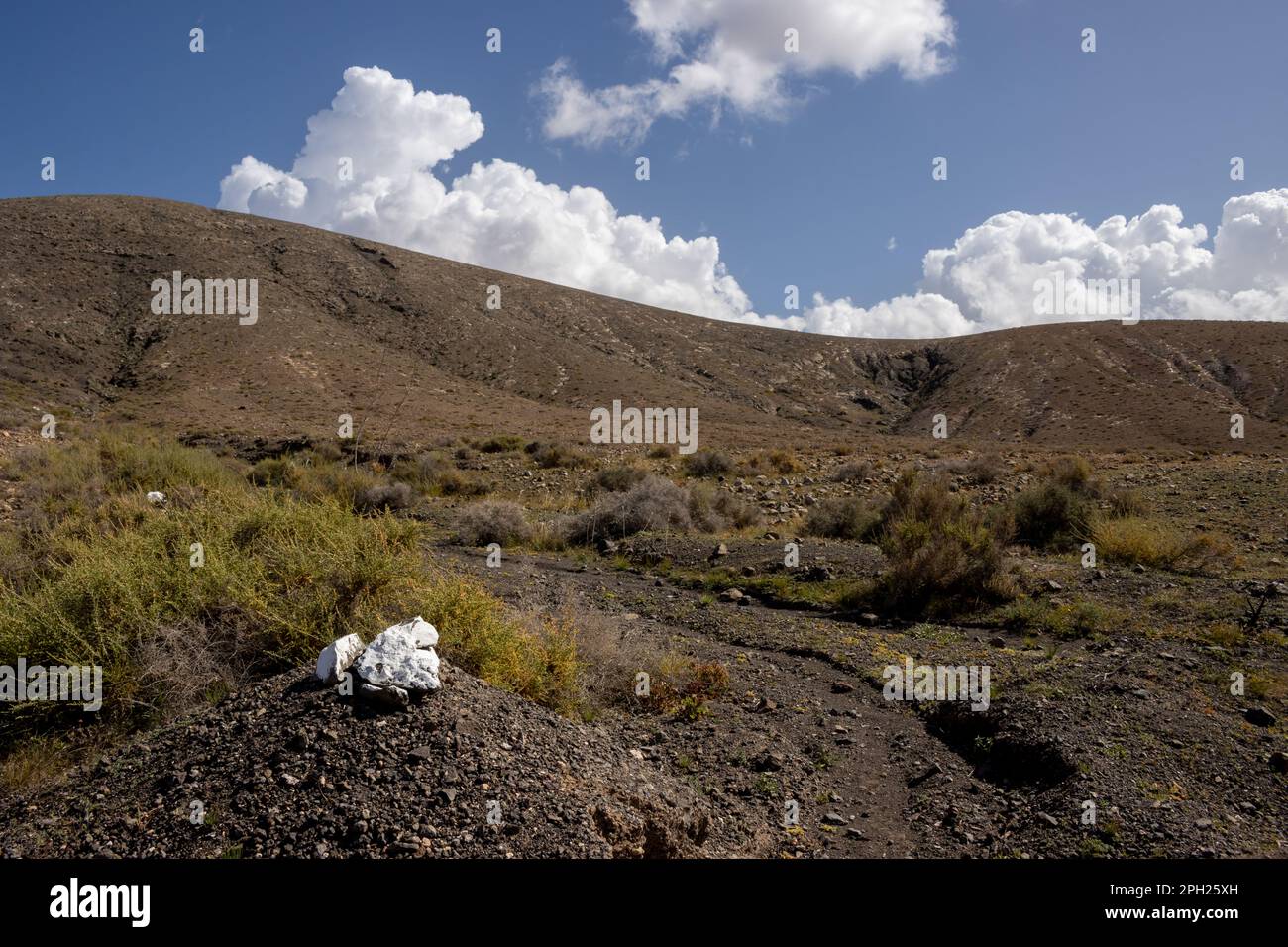 Dry volcanic rocky mountains around a plateau in the centre of the ...