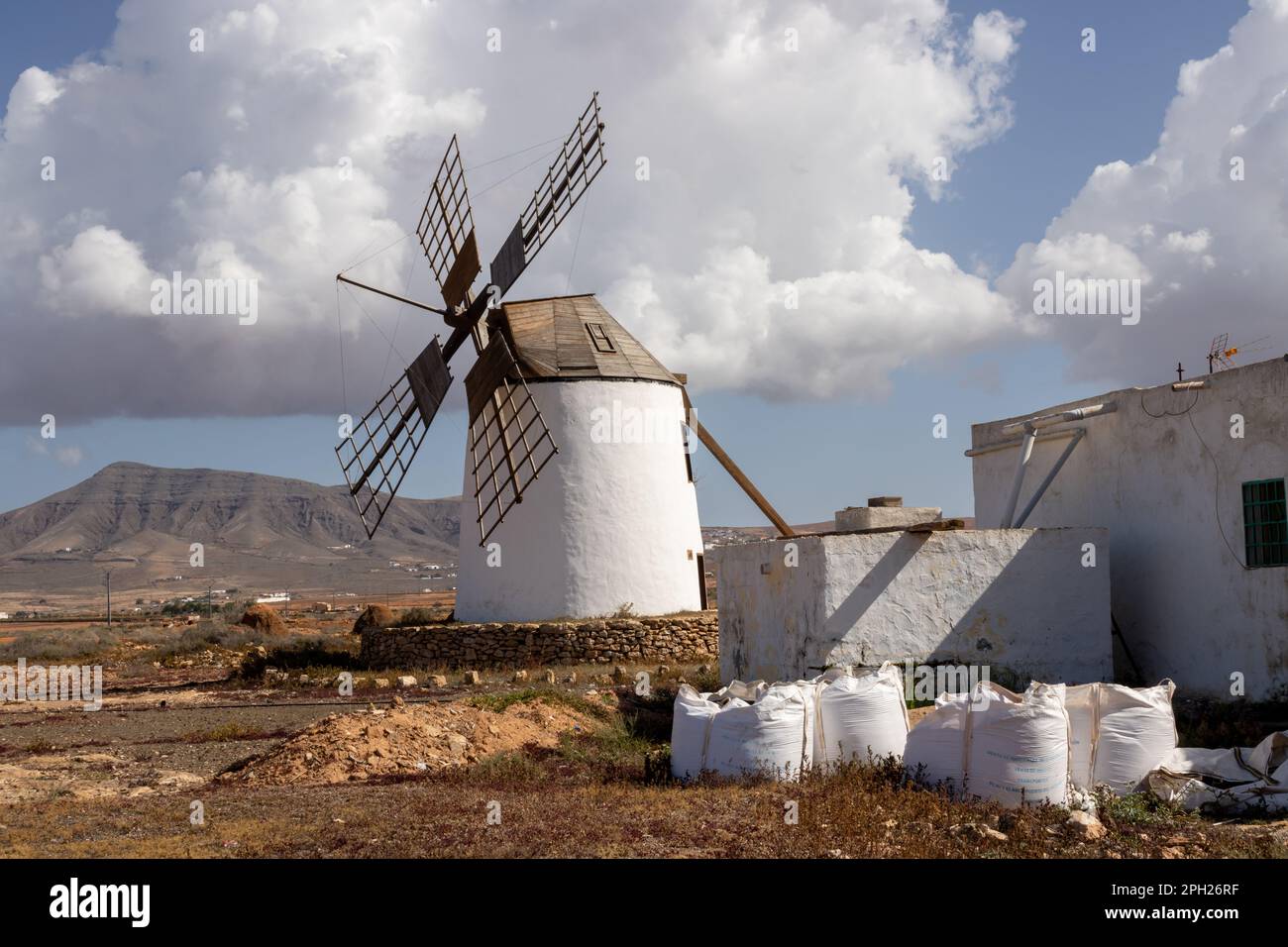 Round shape of the white windmill. Traditional way of grounding the ...