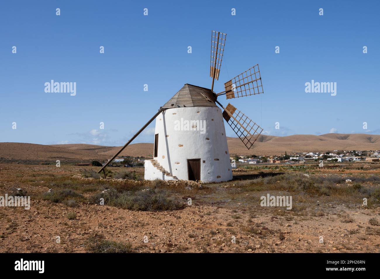 Round shape of the white windmill. Traditional way of grounding the ...