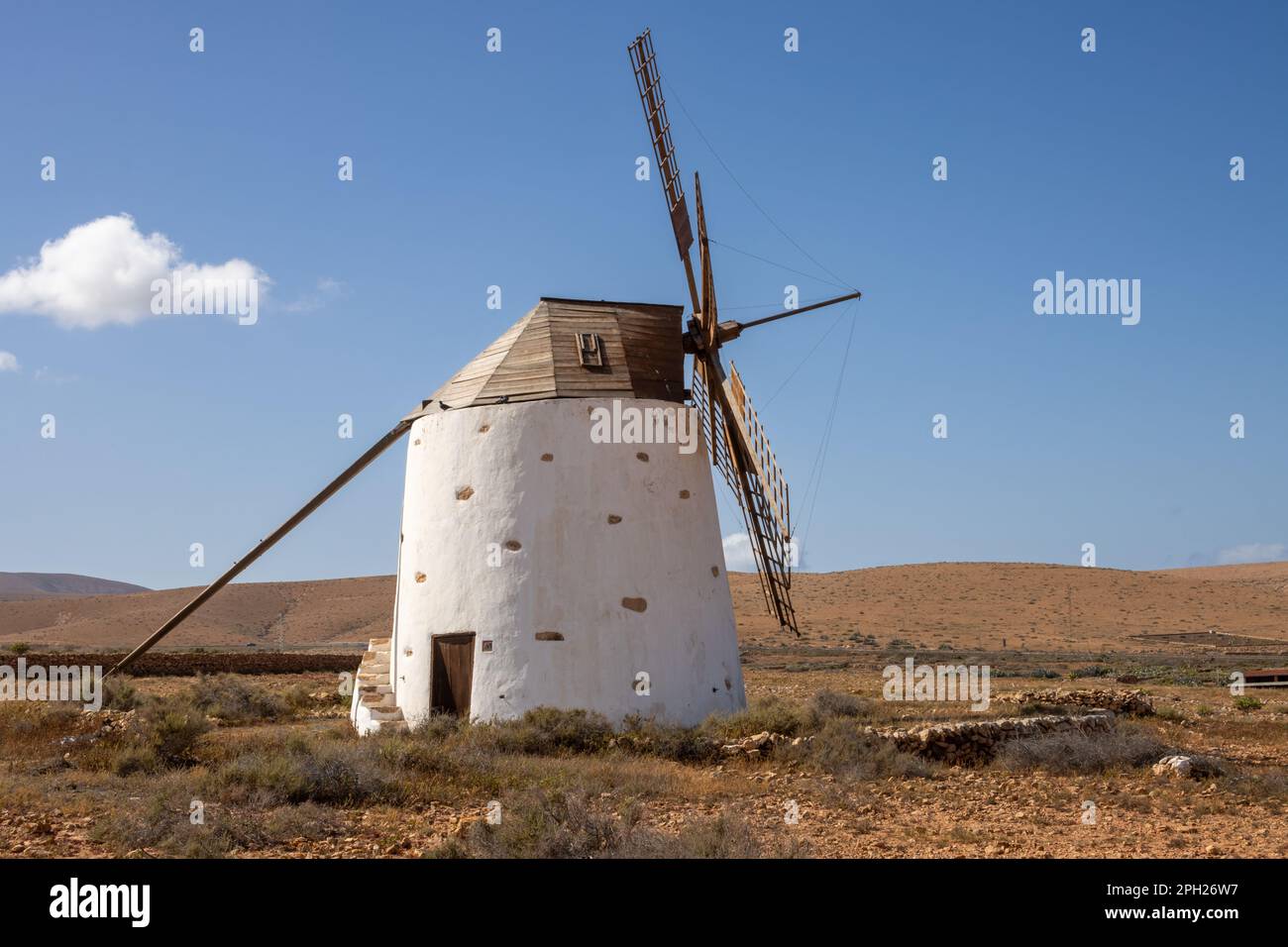 Round shape of the white windmill. Traditional way of grounding the ...