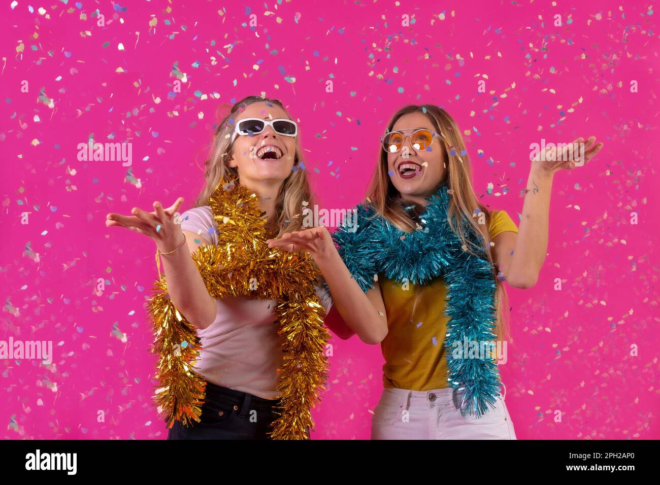 Two females wearing eyeglasses celebrating a momentous occasion by ...