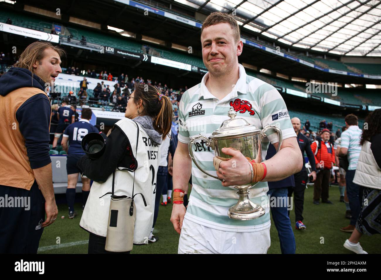 Cambridge captain Ben Gompels smiles with the trophy after winning the ...