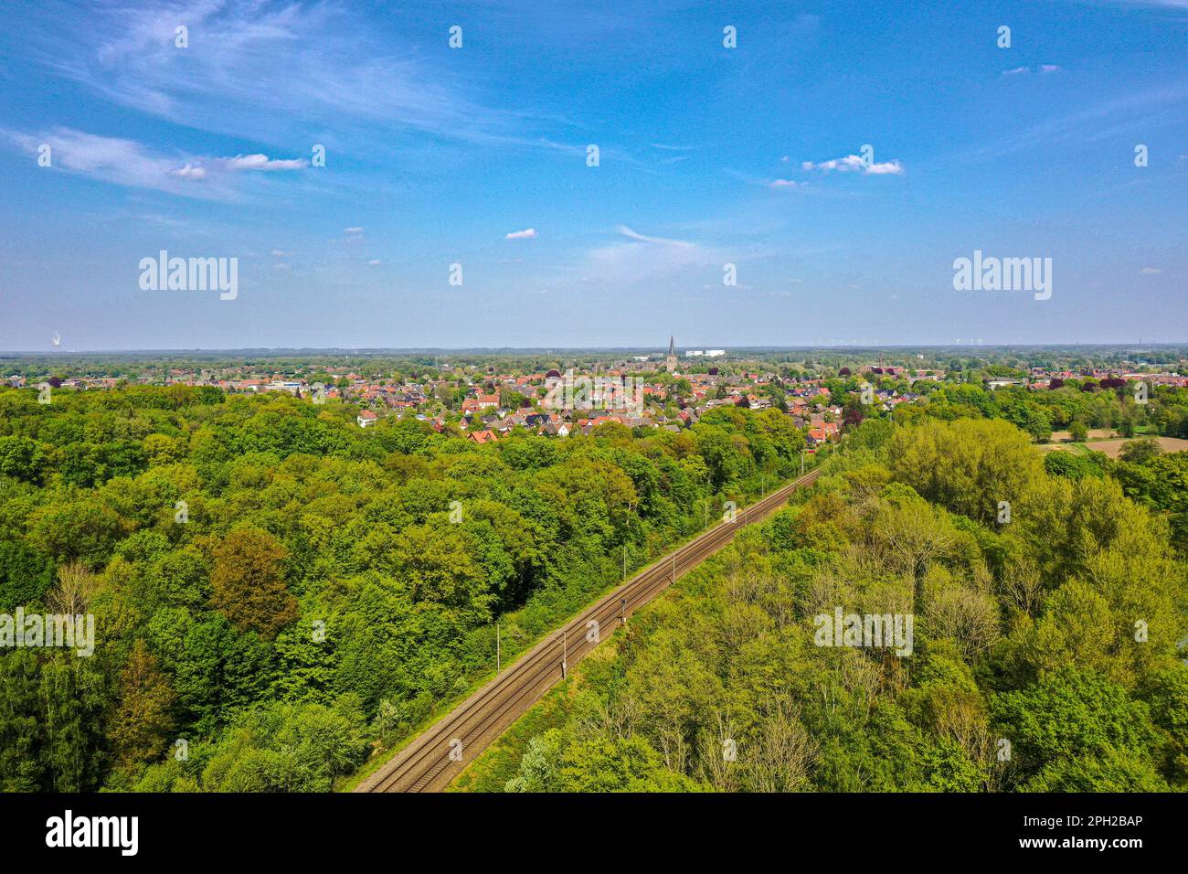An aerial view of a small town landscape with trees and an empty ...