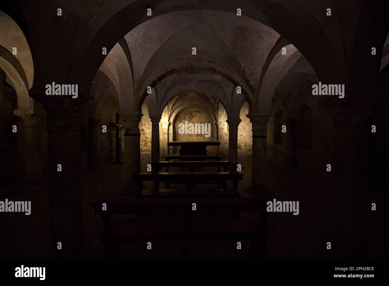 Crypt with benches and altar in the old dome of Brescia Stock Photo - Alamy