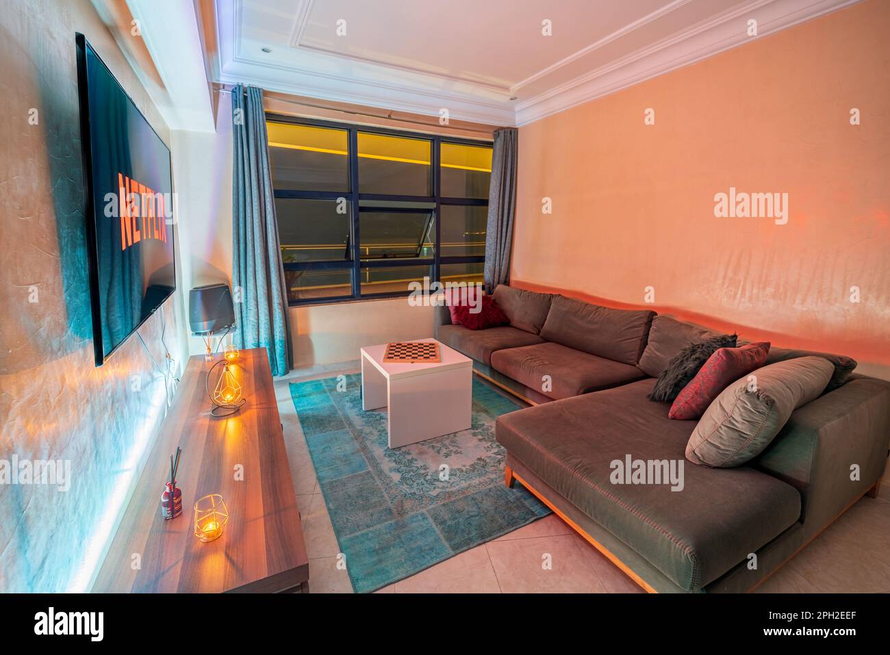 Cozy living room with the Netflix logo on a large smart TV Stock Photo ...