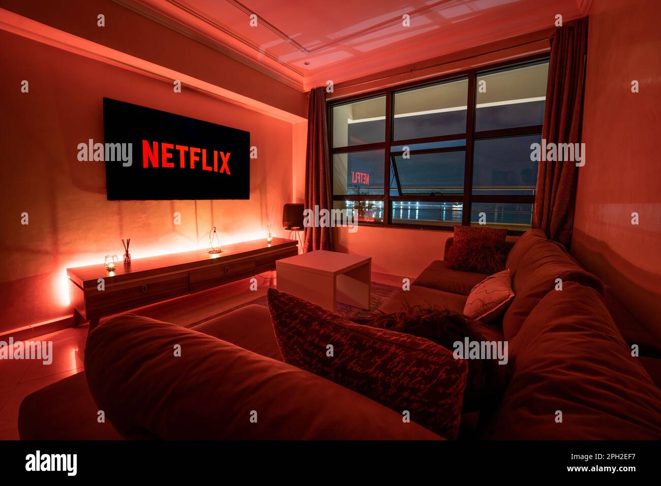 Cozy living room with the Netflix logo on a large smart TV Stock Photo ...