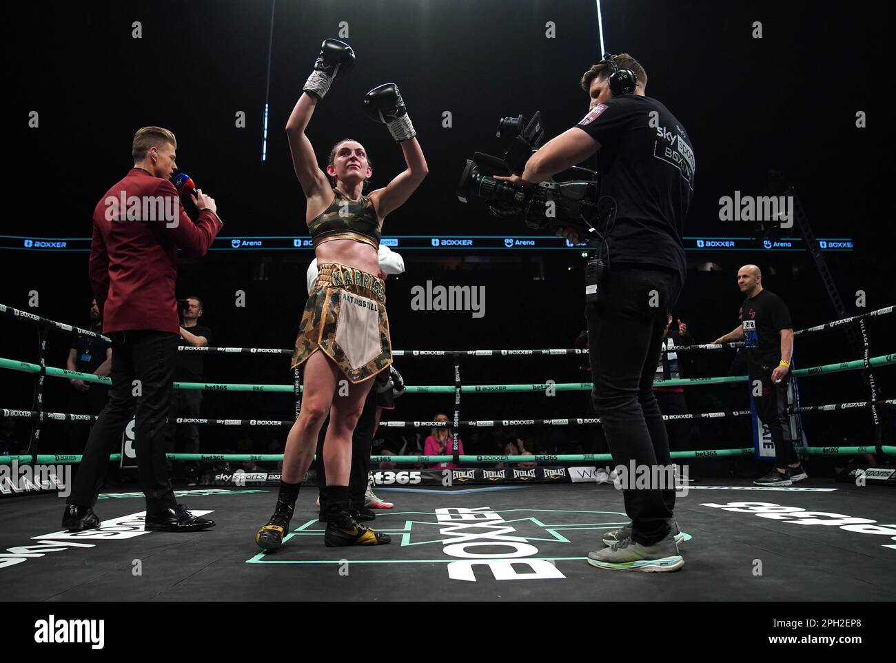 Karriss Artingstall celebrates victory in the super featherweight bout ...