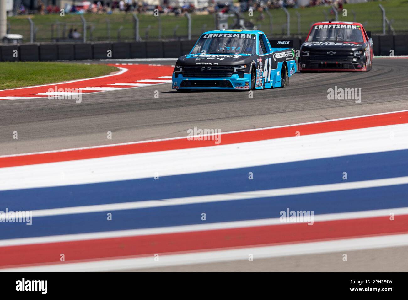 Ross Chastain, left, and Kyle Busch steer their trucks through Turn 17 ...