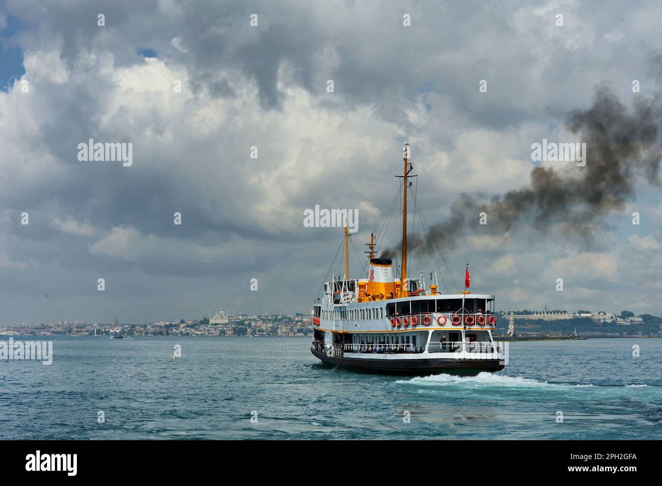 Istanbul's classic steamboat, with smoke coming out of its chimney, is ...