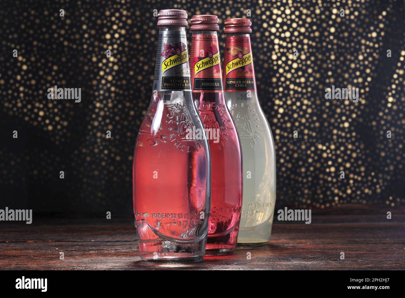 Koszalin, Poland, March 25, 2023. Schweppes Glass bottle on an abstract ...