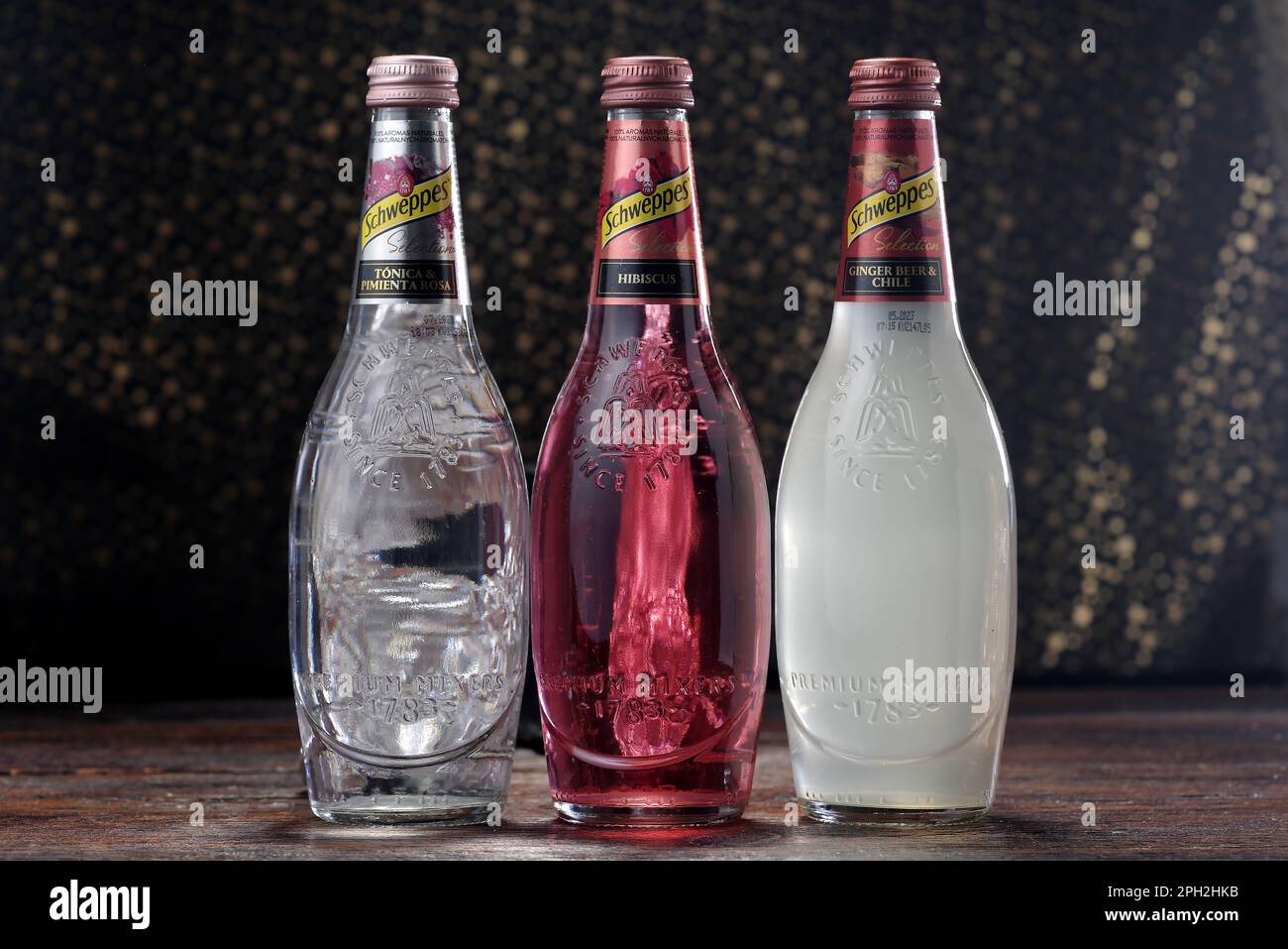 Koszalin, Poland, March 25, 2023. Schweppes Glass bottle on an abstract ...