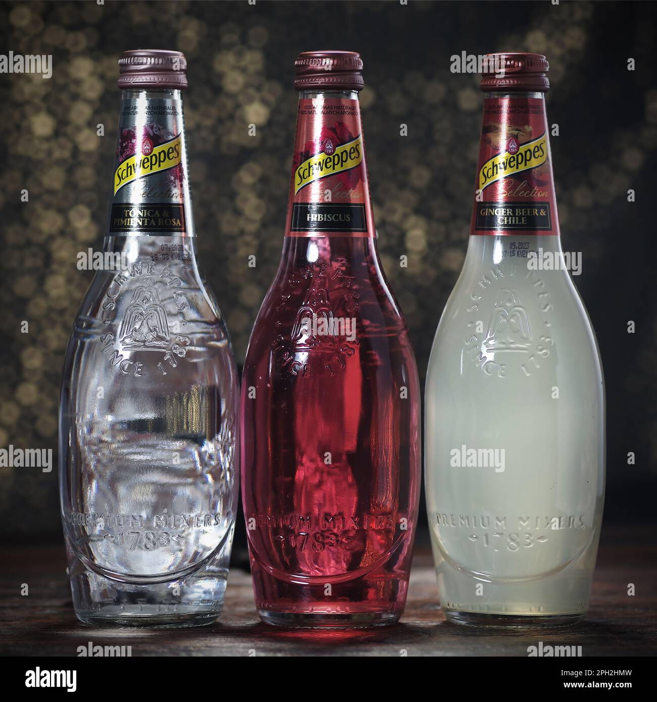 Koszalin, Poland, March 25, 2023. Schweppes Glass bottle on an abstract ...