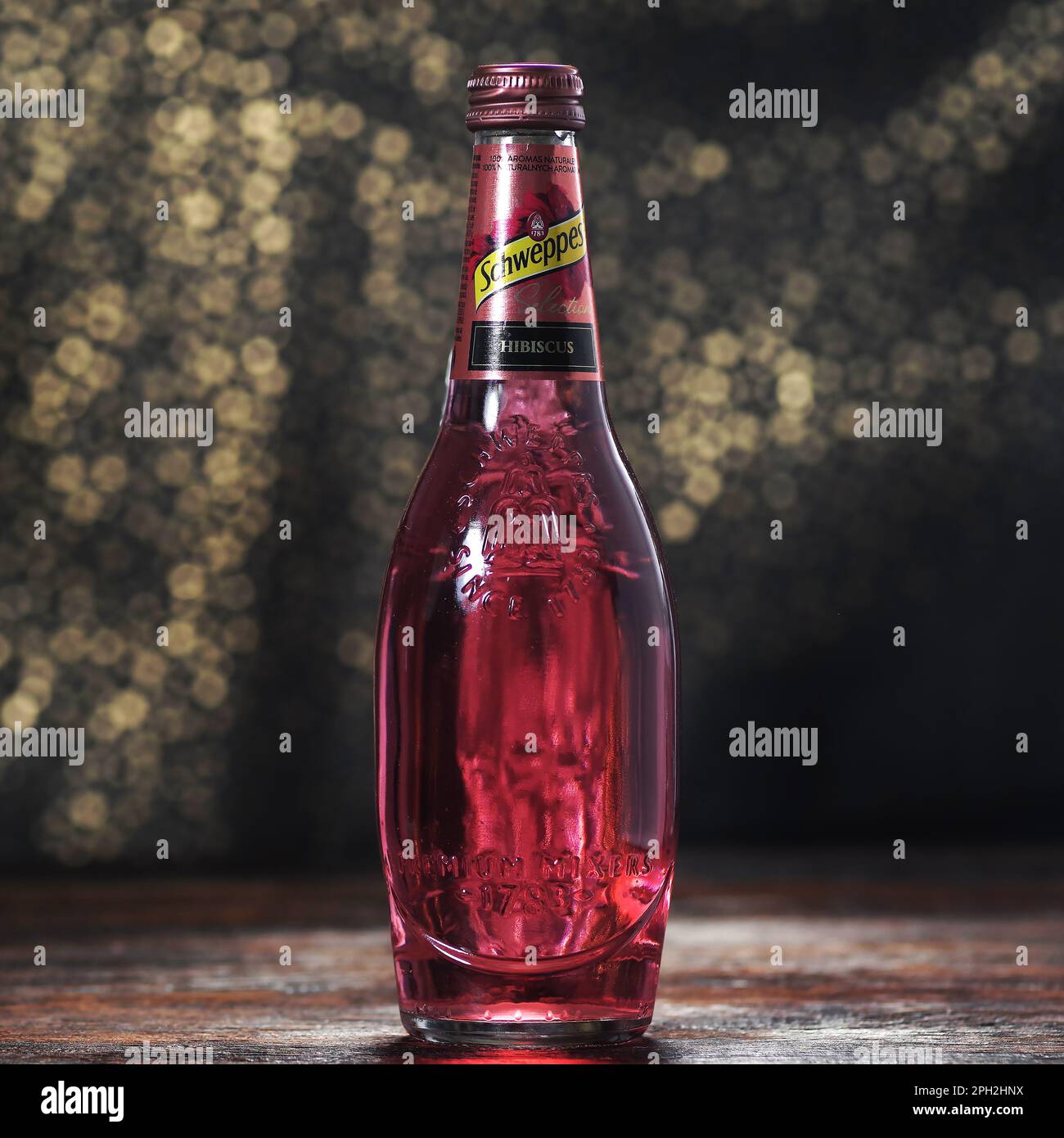 Koszalin, Poland, March 25, 2023. Schweppes Glass bottle on an abstract ...