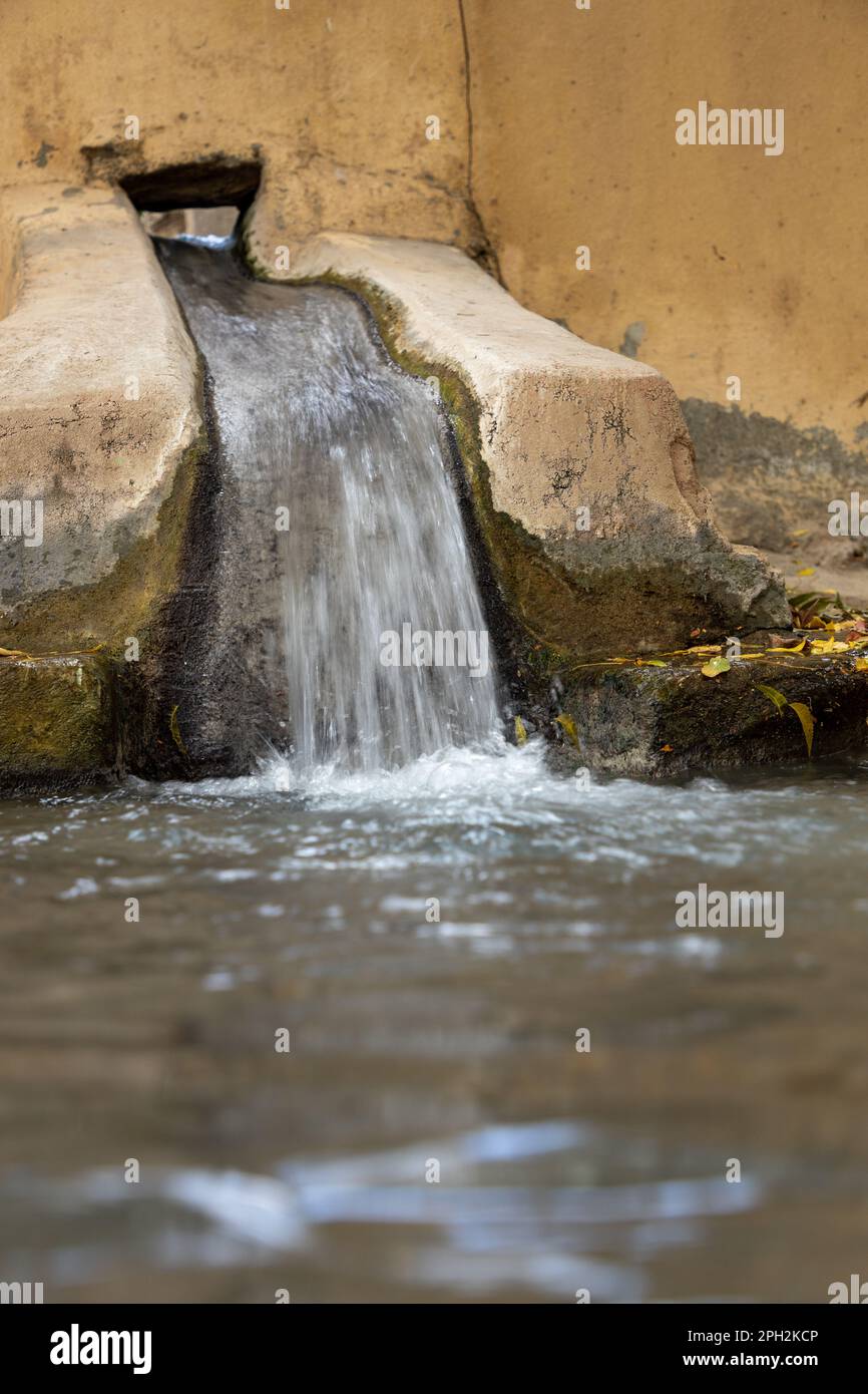 Gushing water from an old mud built tank Stock Photo - Alamy