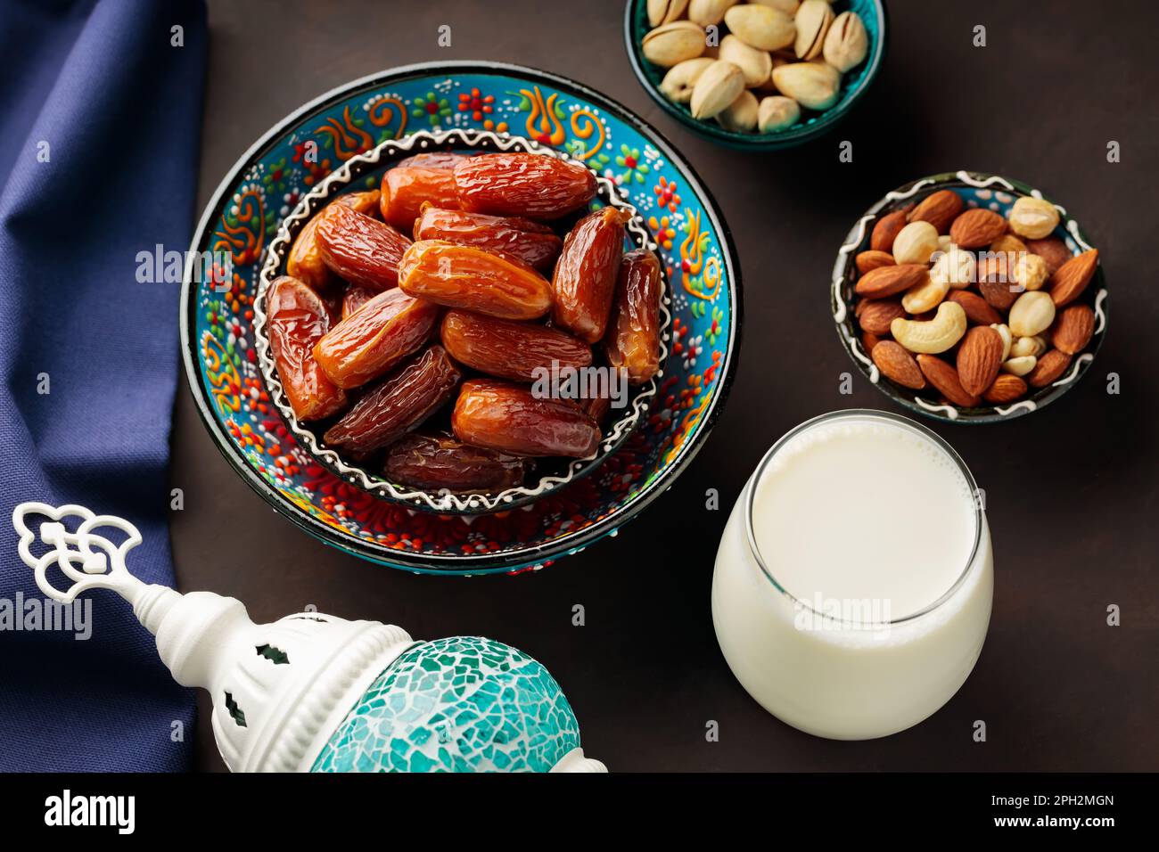 Dried dates, nuts and milk on a dark background. Ramadan Kareem and ...