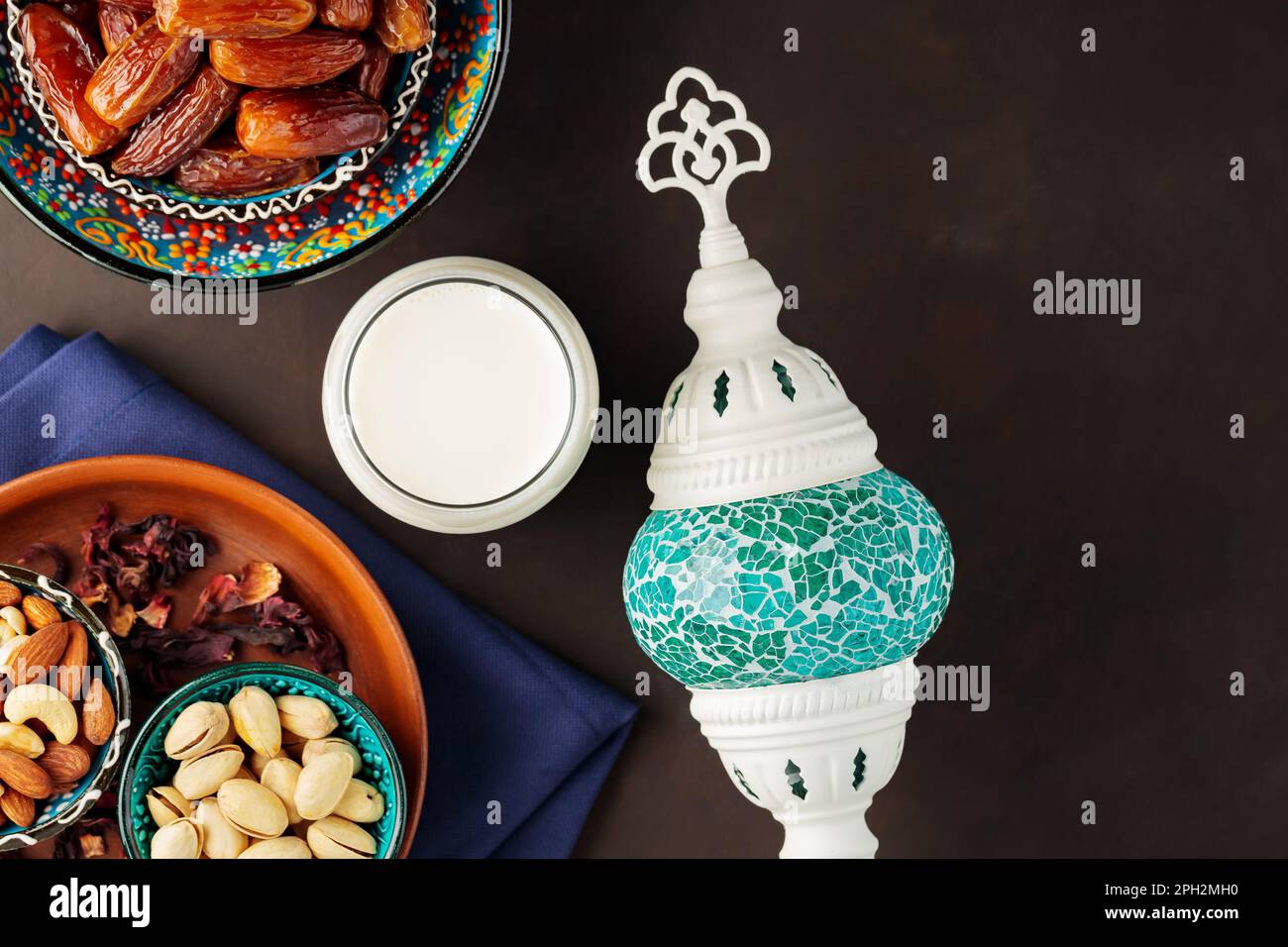 Dried dates, nuts and milk on a dark background. Ramadan Kareem and ...