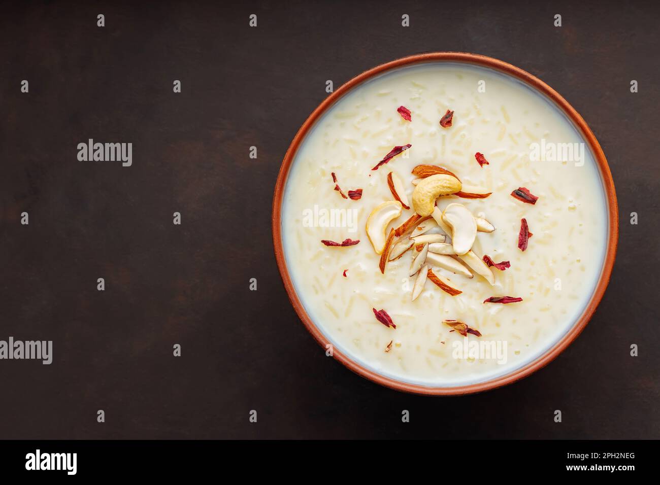 Bowl with rice pudding on dark background. Creamy rice kheer with ...