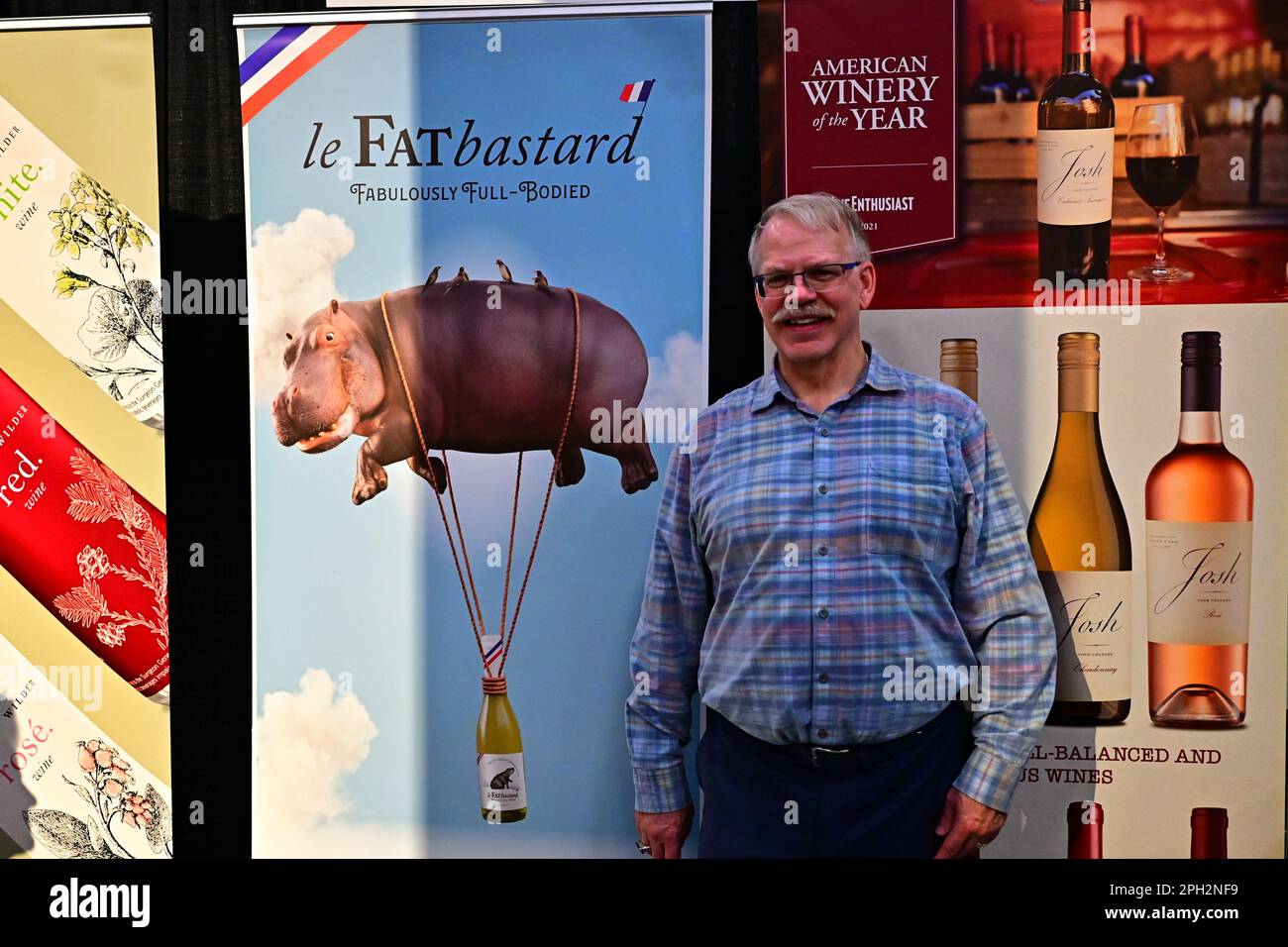 A Fat Bastard wine vendor poses in front of the poster during 2023 ...