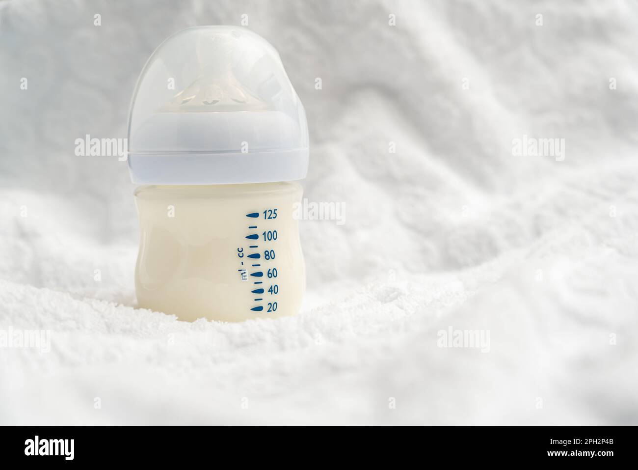 Baby milk formula in small bottle on white fluffy background Stock ...