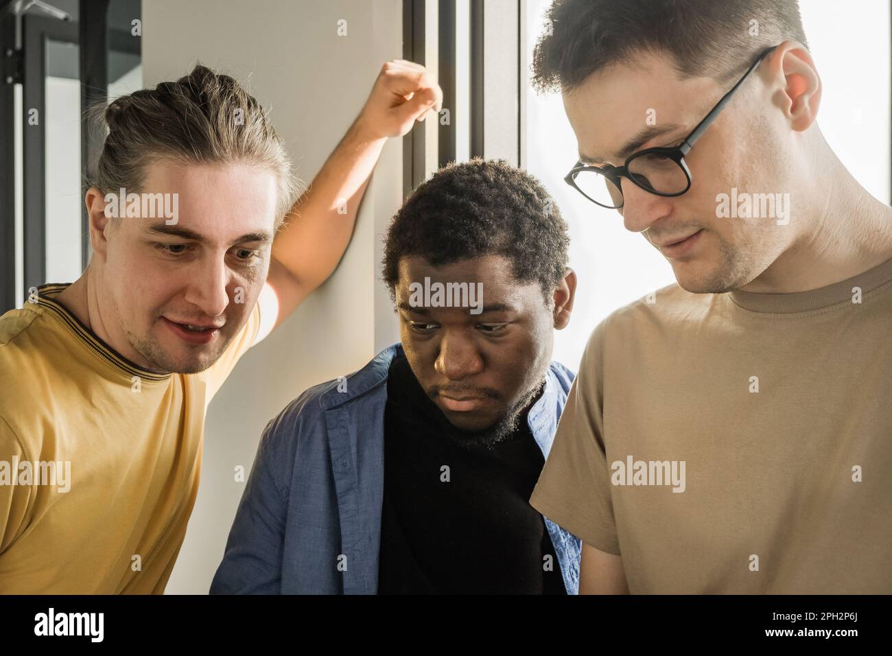 A young developer gives new project tasks to his partners. Business ...