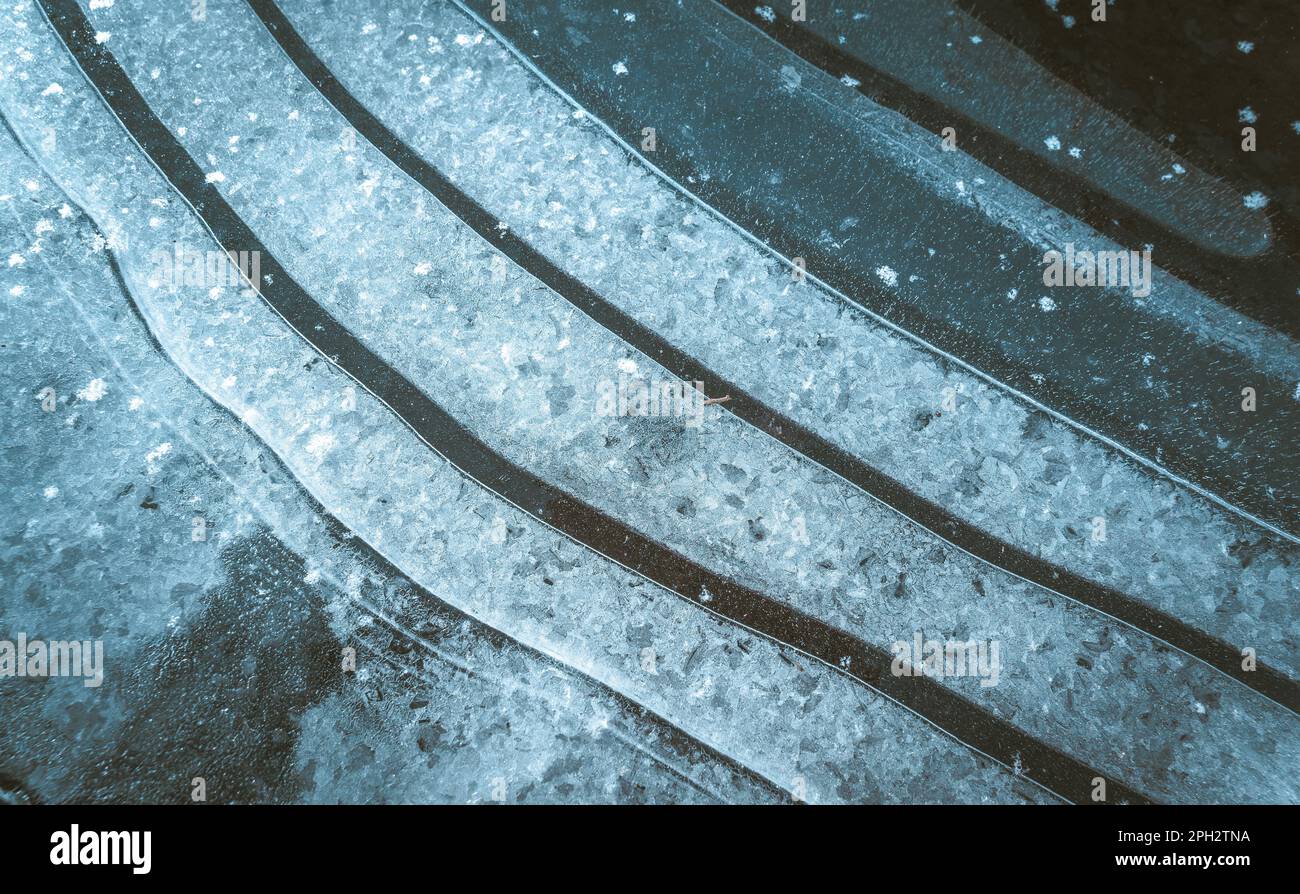 Sharp and clean lines of black and white stripes formed by ice and snow ...
