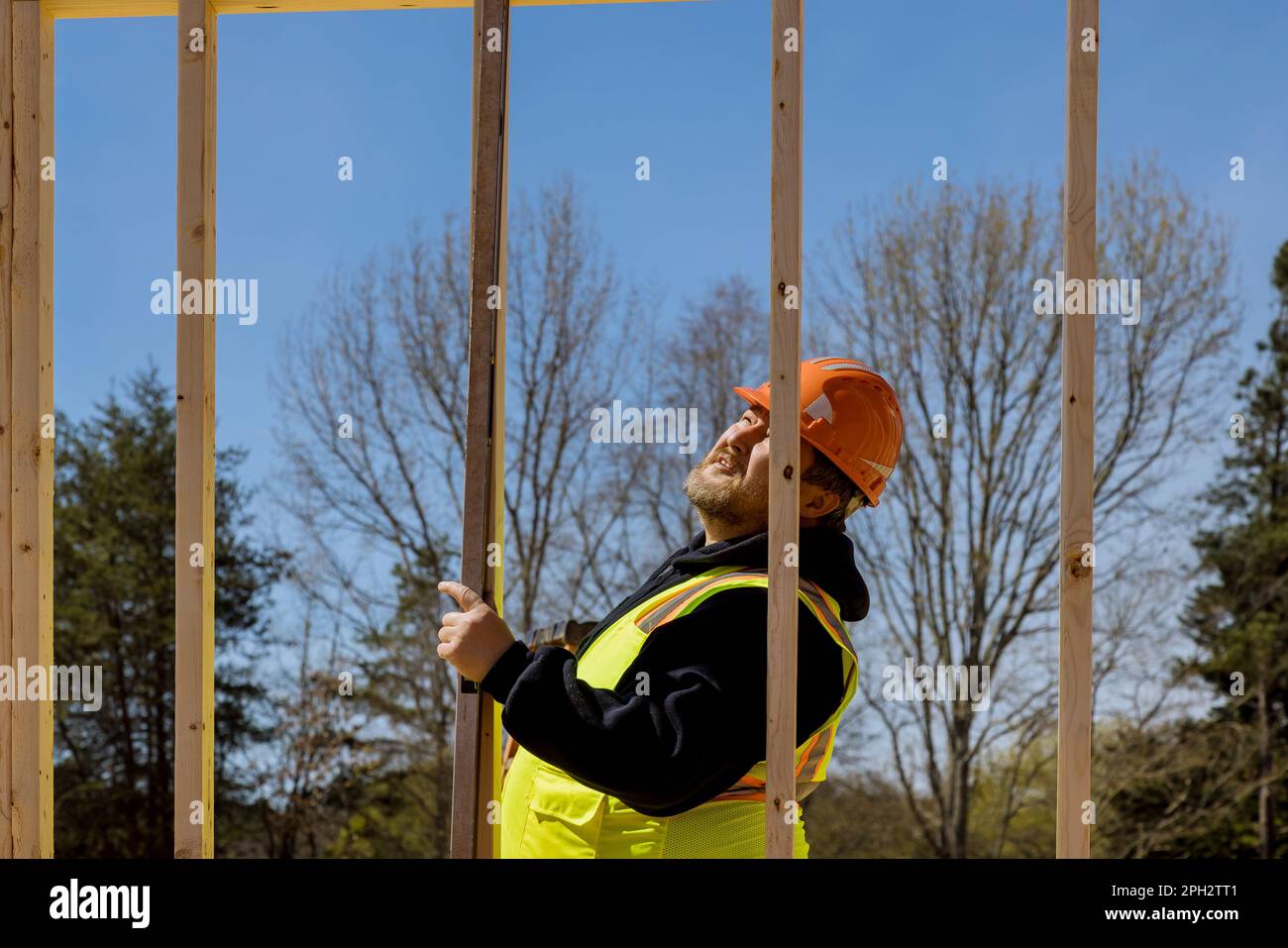 As construction engineer checking leveling quality of wooden frame ...