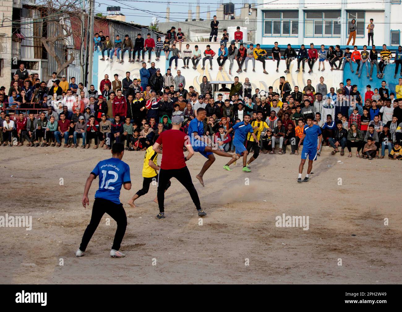 Palestinian youths play football during the holy month of Ramadan in ...