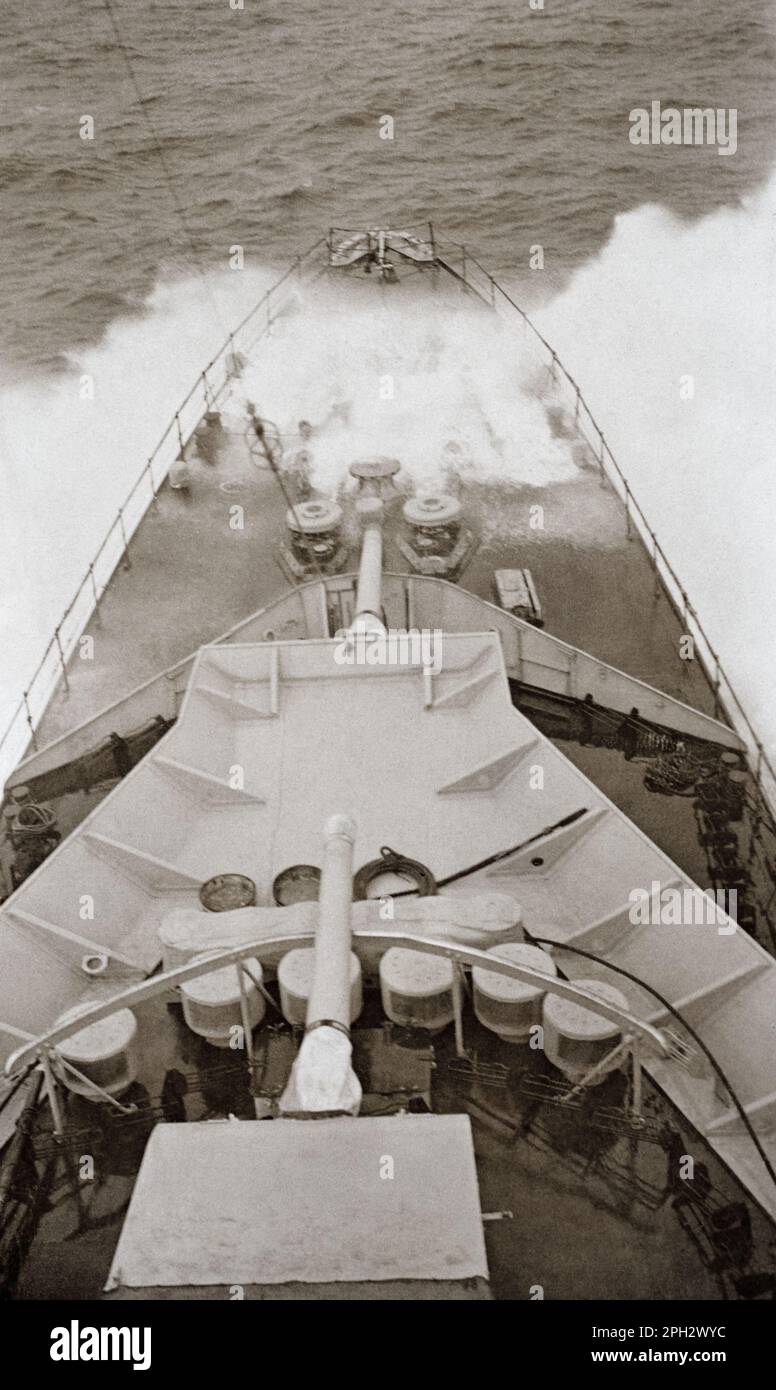 The Royal Navy light cruiser HMS Danae breaking through waves in the ...