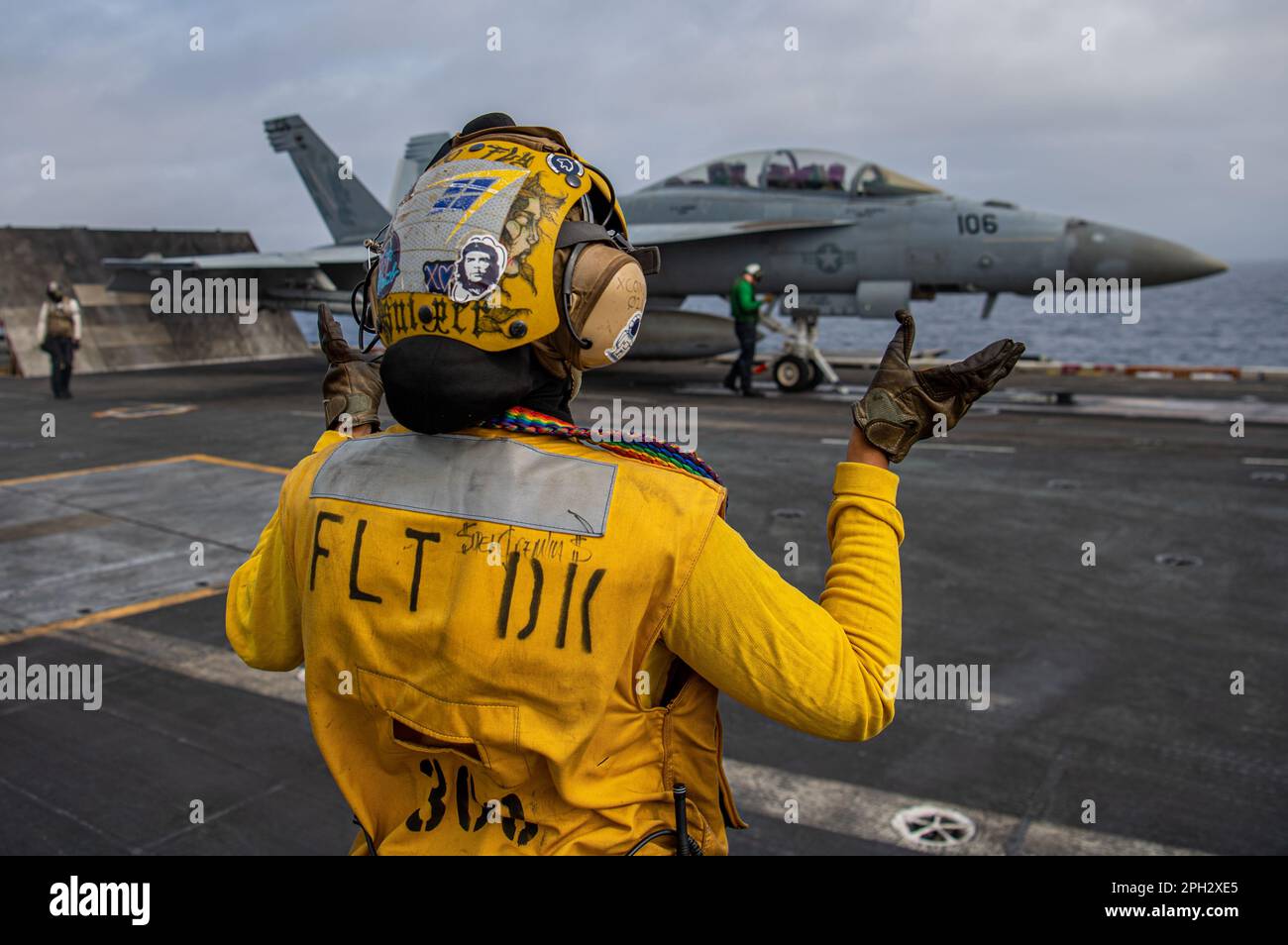 230324-N-DU622-1081 PHILIPPINE SEA (March 24, 2023) A U.S. Navy Sailor directs an F/A-18E Super ...